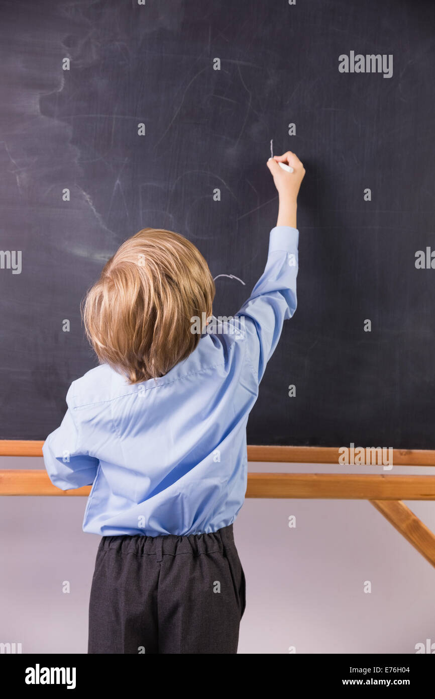 Student writing on large blackboard Stock Photo - Alamy