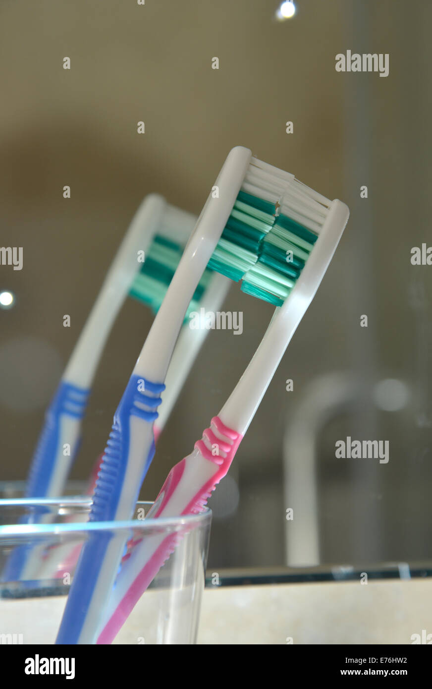 Pink and blue toothbrushes kissing Stock Photo - Alamy