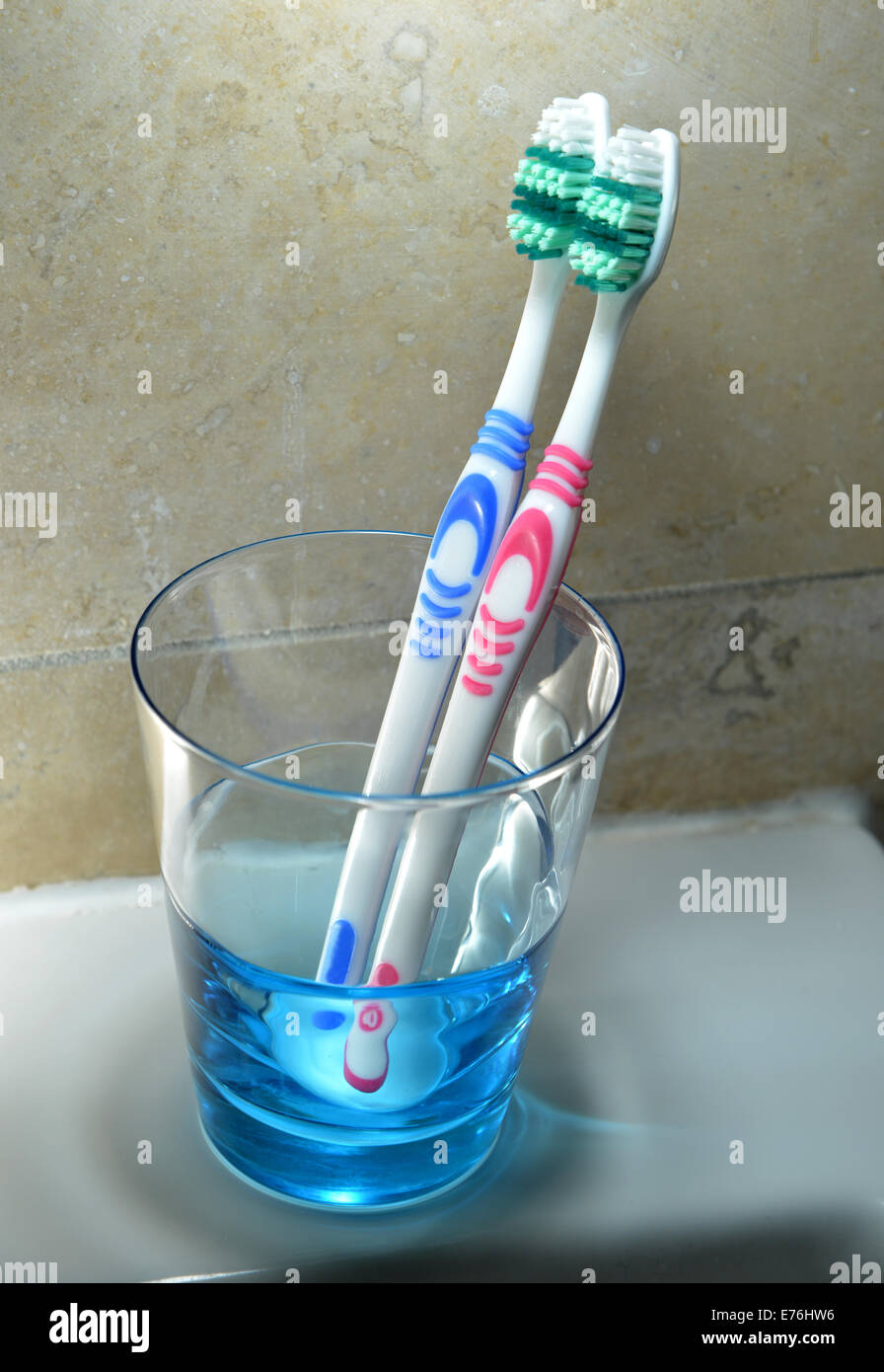 Pink and blue toothbrushes side by side Stock Photo - Alamy