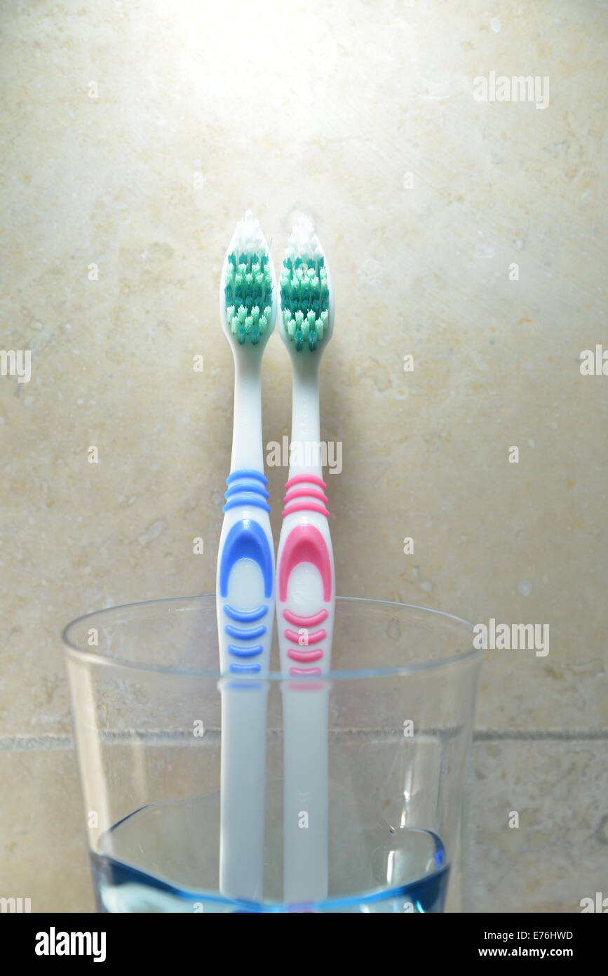 Pink and blue toothbrushes side by side Stock Photo - Alamy
