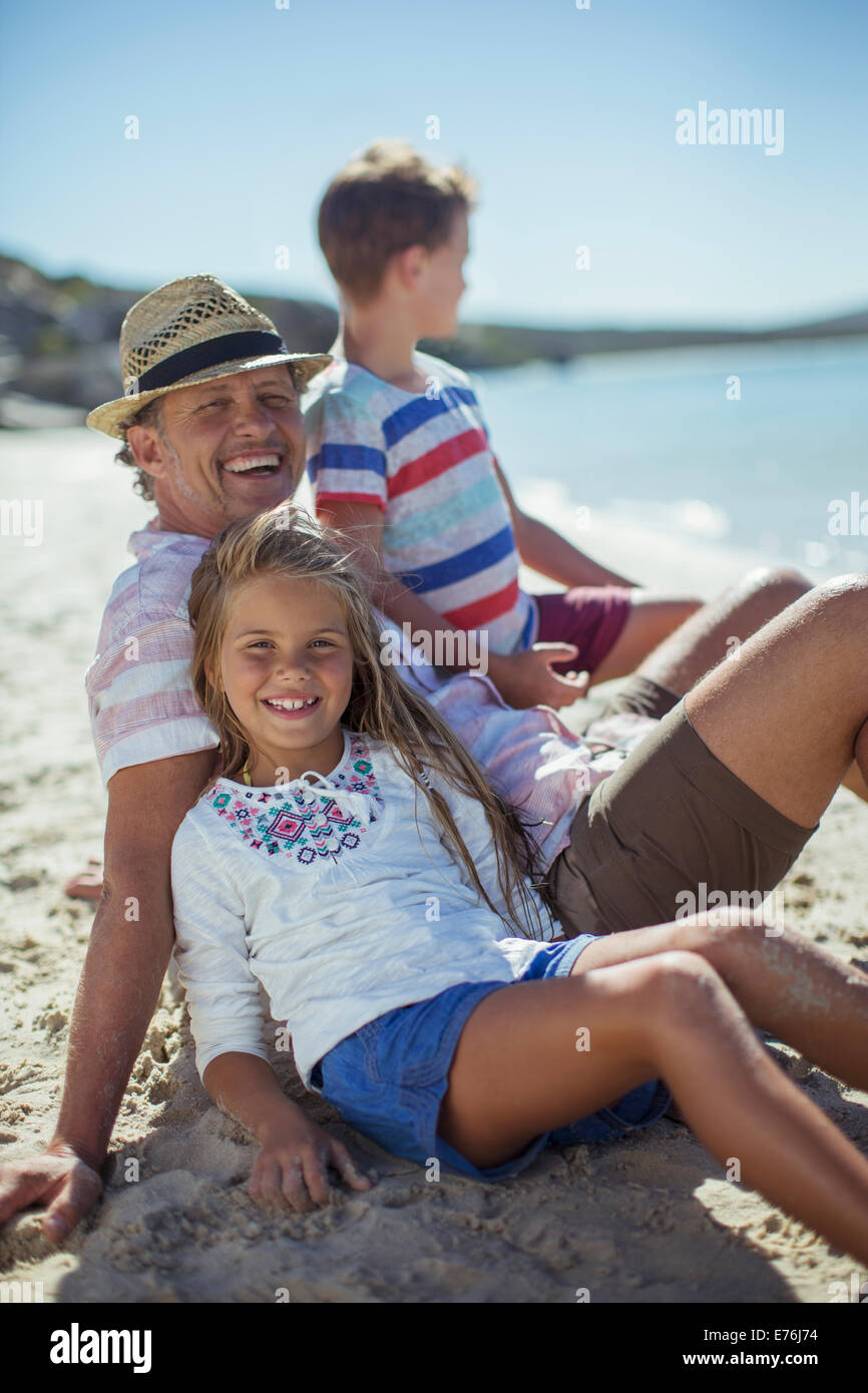Family sitting in sand together Stock Photo - Alamy