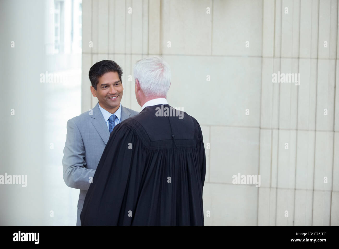 Lawyer and judge talking in courthouse Stock Photo - Alamy