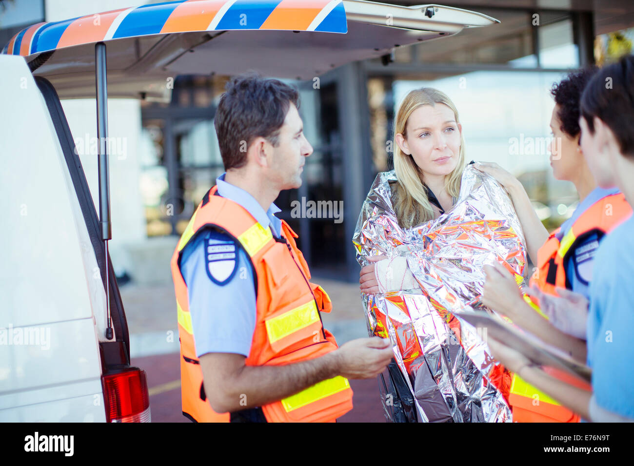 Paramedics talking to patient in hospital parking lot Stock Photo - Alamy