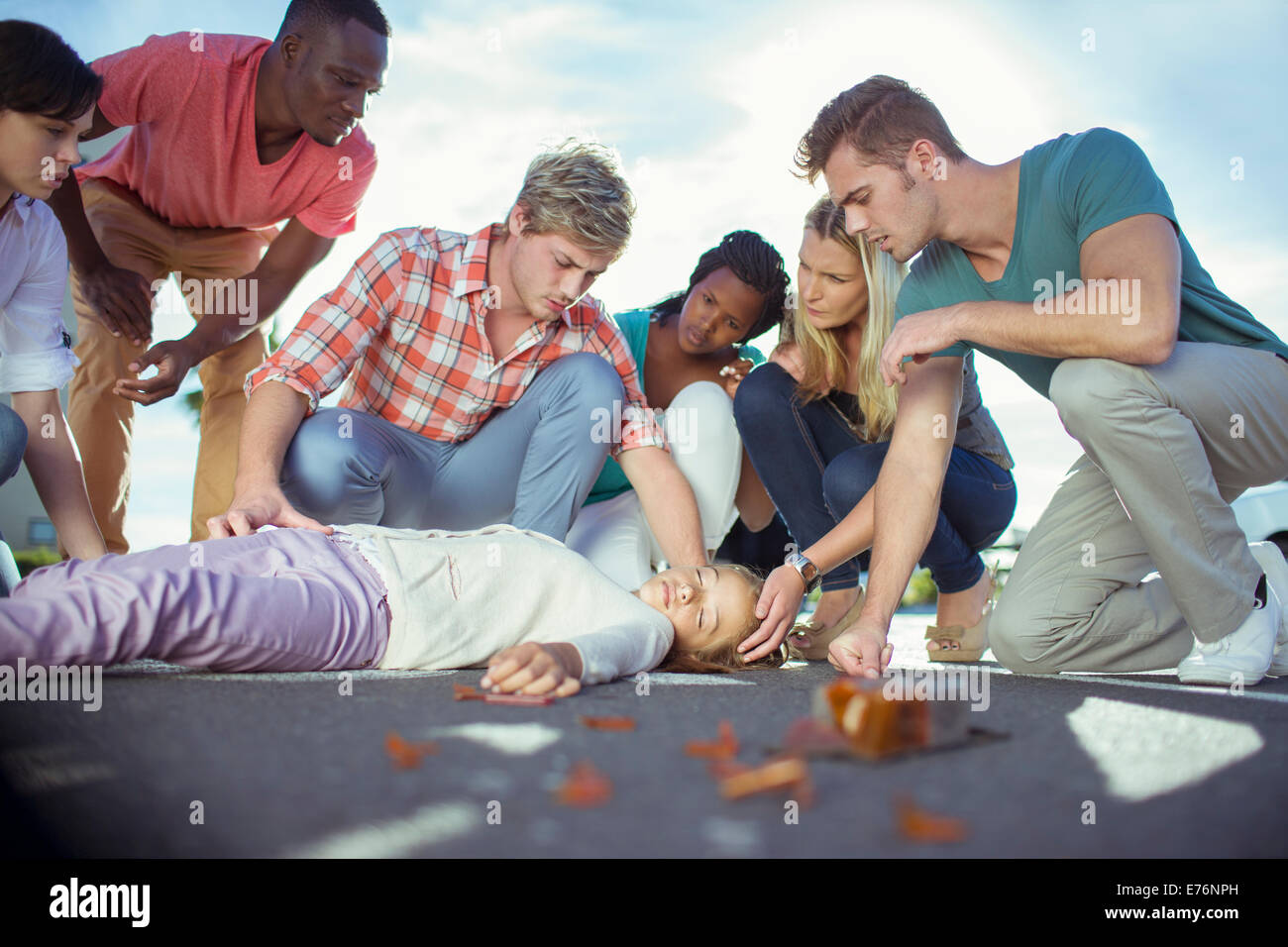 People rushing to injured girl on street Stock Photo - Alamy