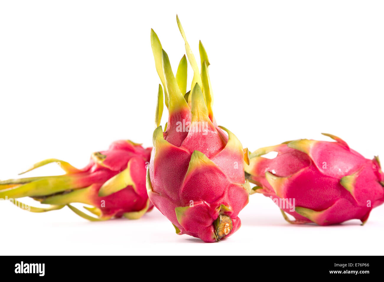 Three exotic pink dragon fruits, selective focus on first fruit ...