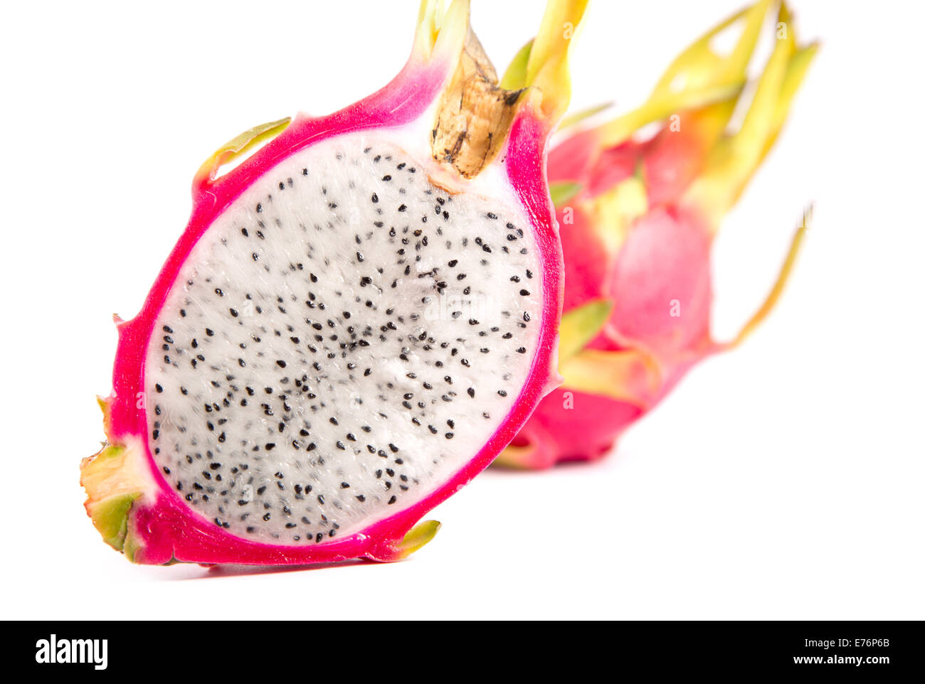 Close-up shot of cut section of dragon fruit, isolated on white ...