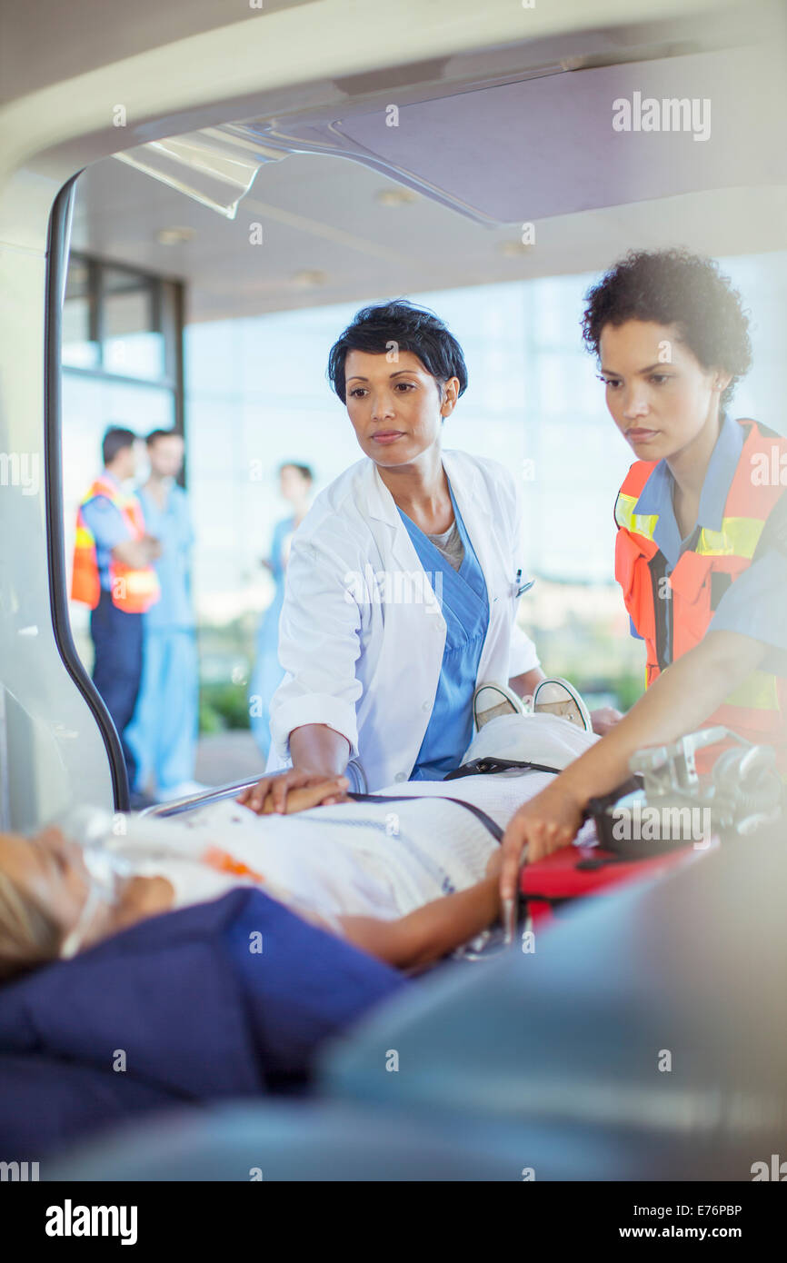 Doctor and paramedic examining patient in ambulance Stock Photo - Alamy