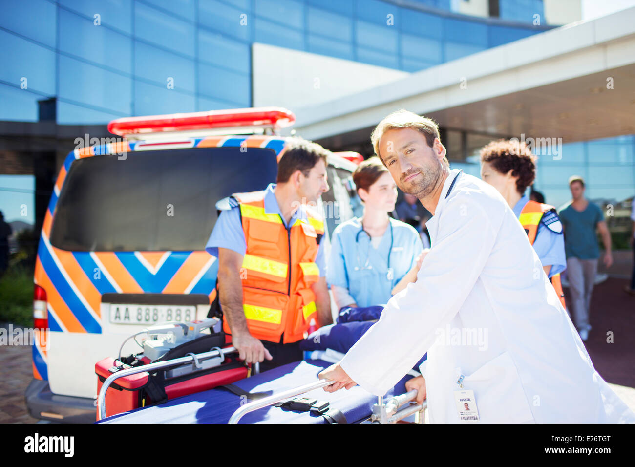 Doctor with paramedics outside hospital Stock Photo - Alamy