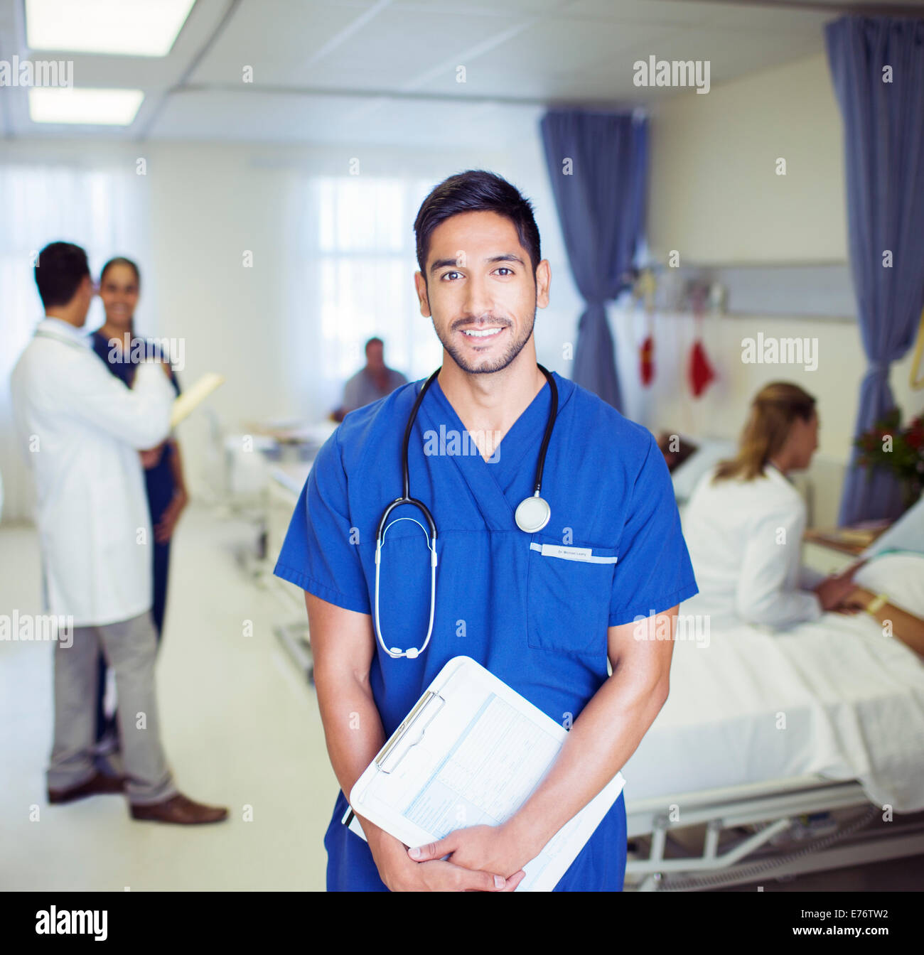 Nurse smiling in hospital room Stock Photo - Alamy