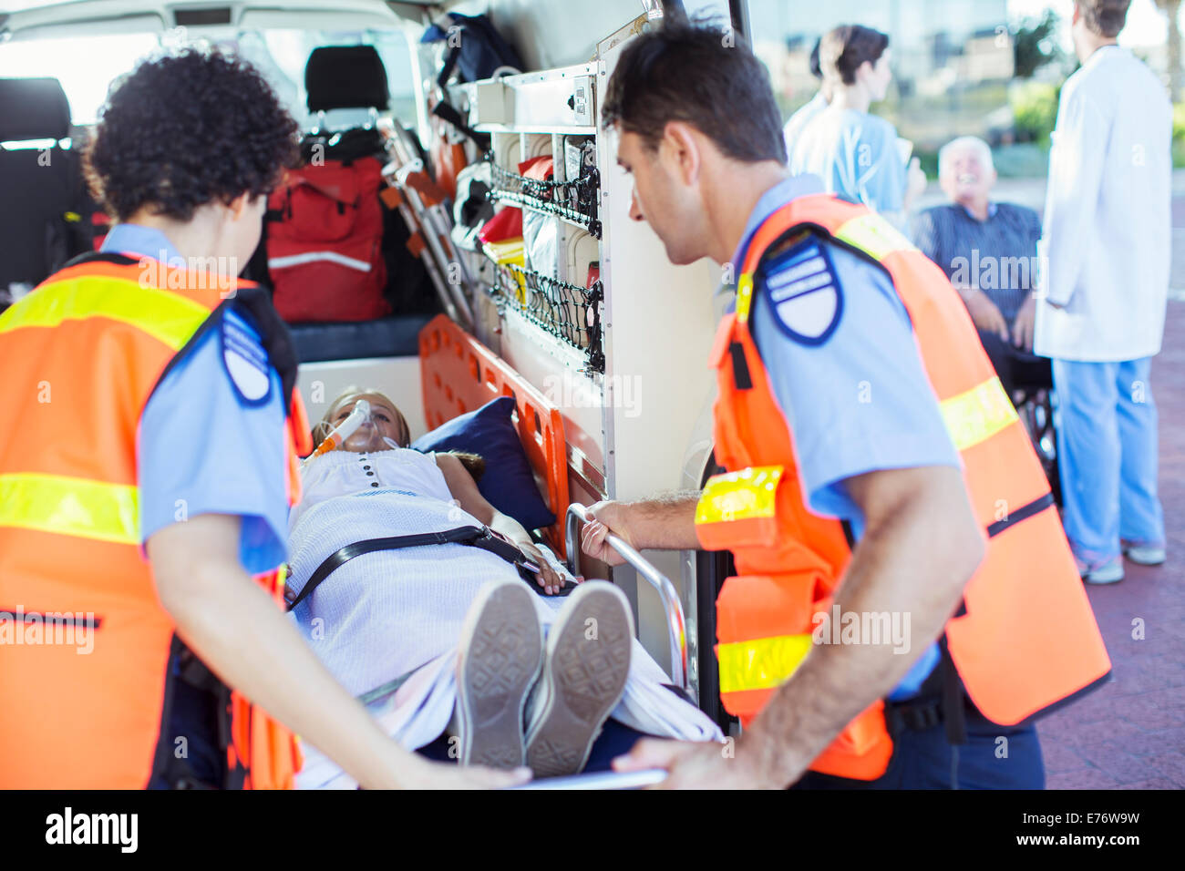 Paramedics examining patient in ambulance Stock Photo - Alamy