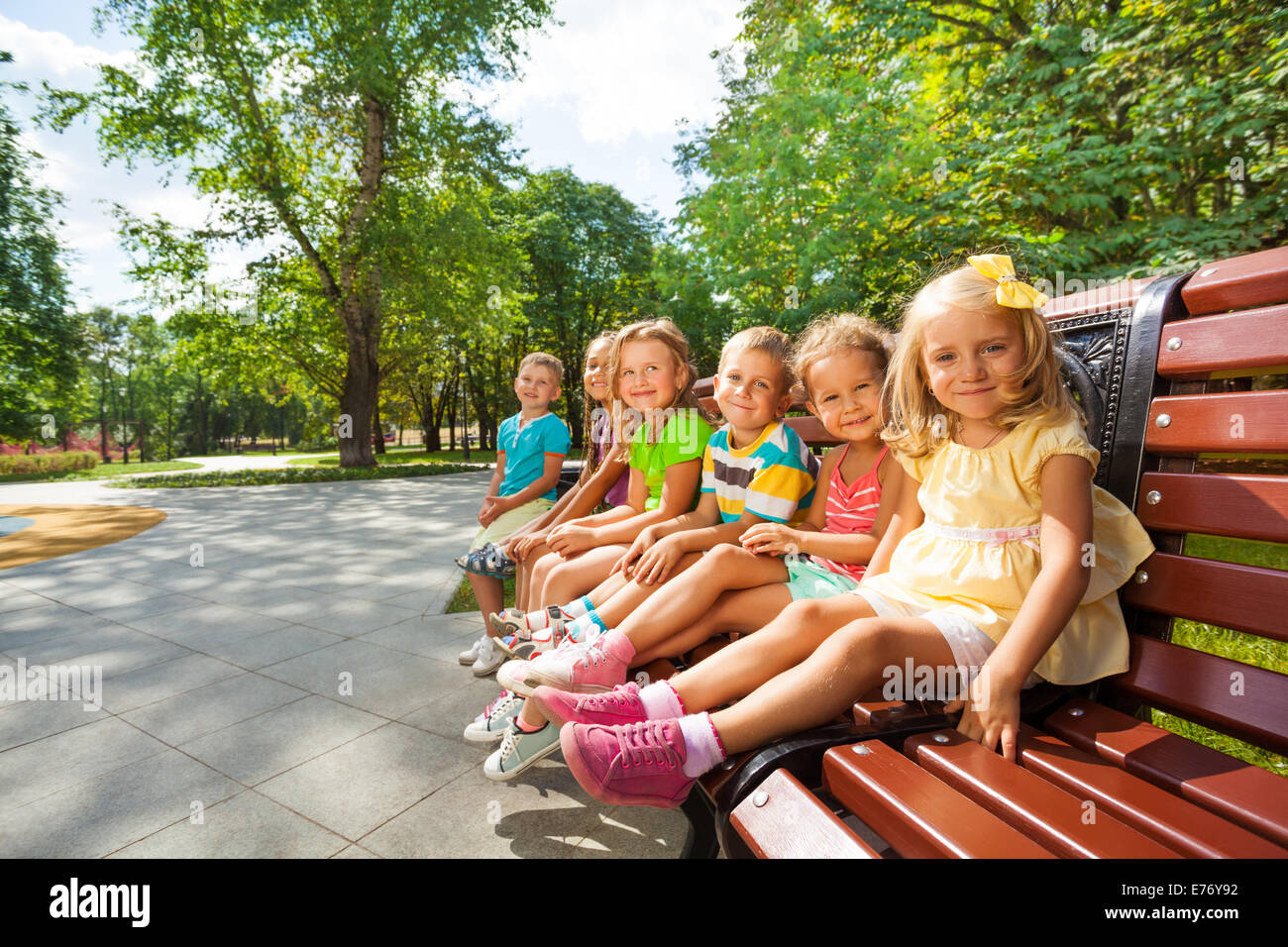 Boys and girls rest in park Stock Photo - Alamy