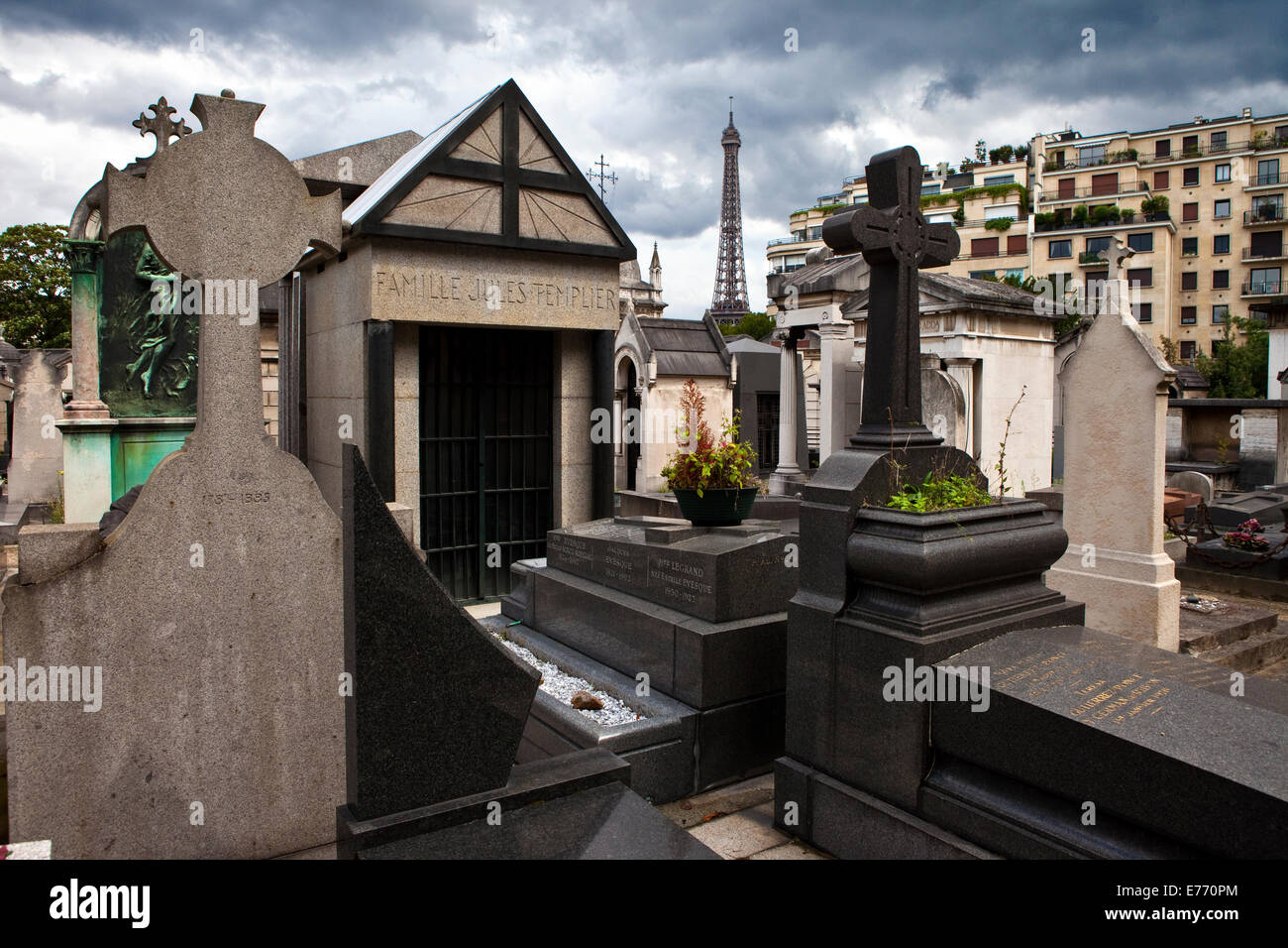 The historic Passy Cemetery in Paris, France. The Eiffel Tower can be ...