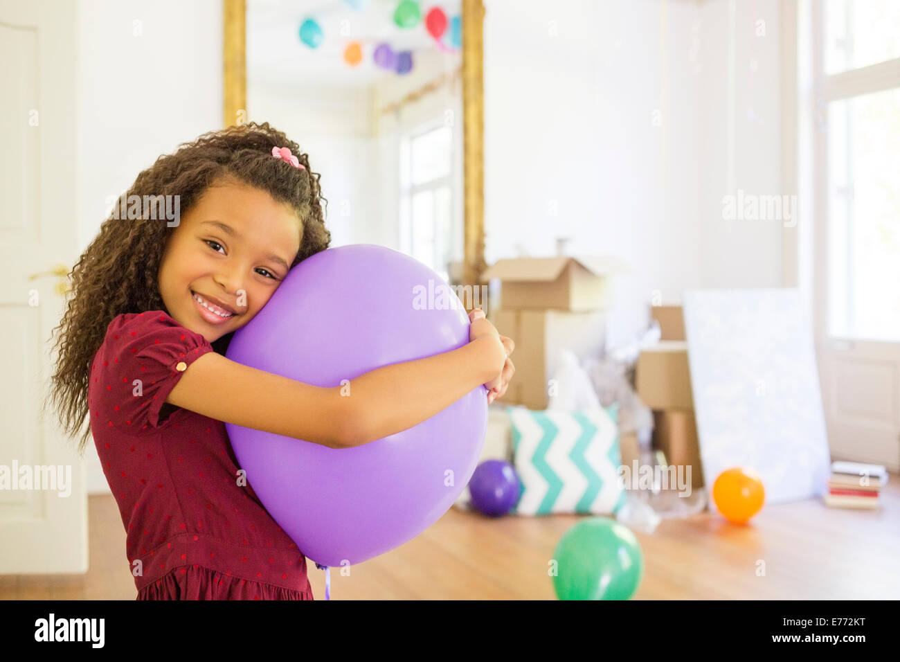 Young girl hugging purple balloon Stock Photo - Alamy