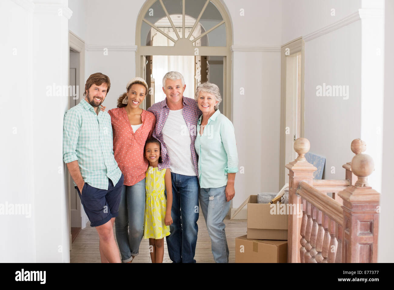 Family smiling together in living space Stock Photo - Alamy