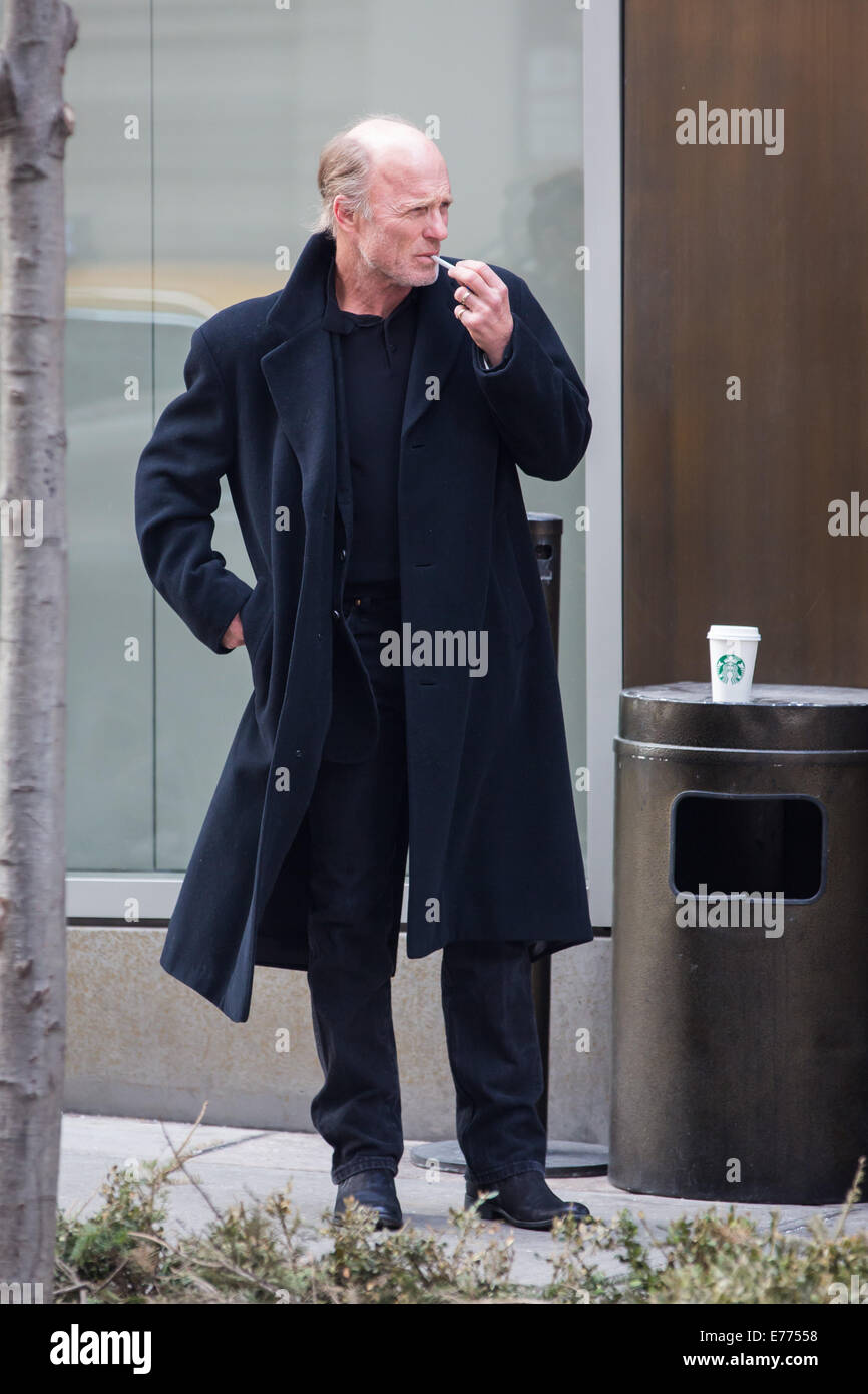 An unshaven Ed Harris lights up a cigarette while taking a coffee break ...
