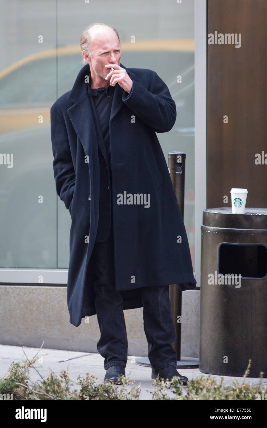 An unshaven Ed Harris lights up a cigarette while taking a coffee break ...