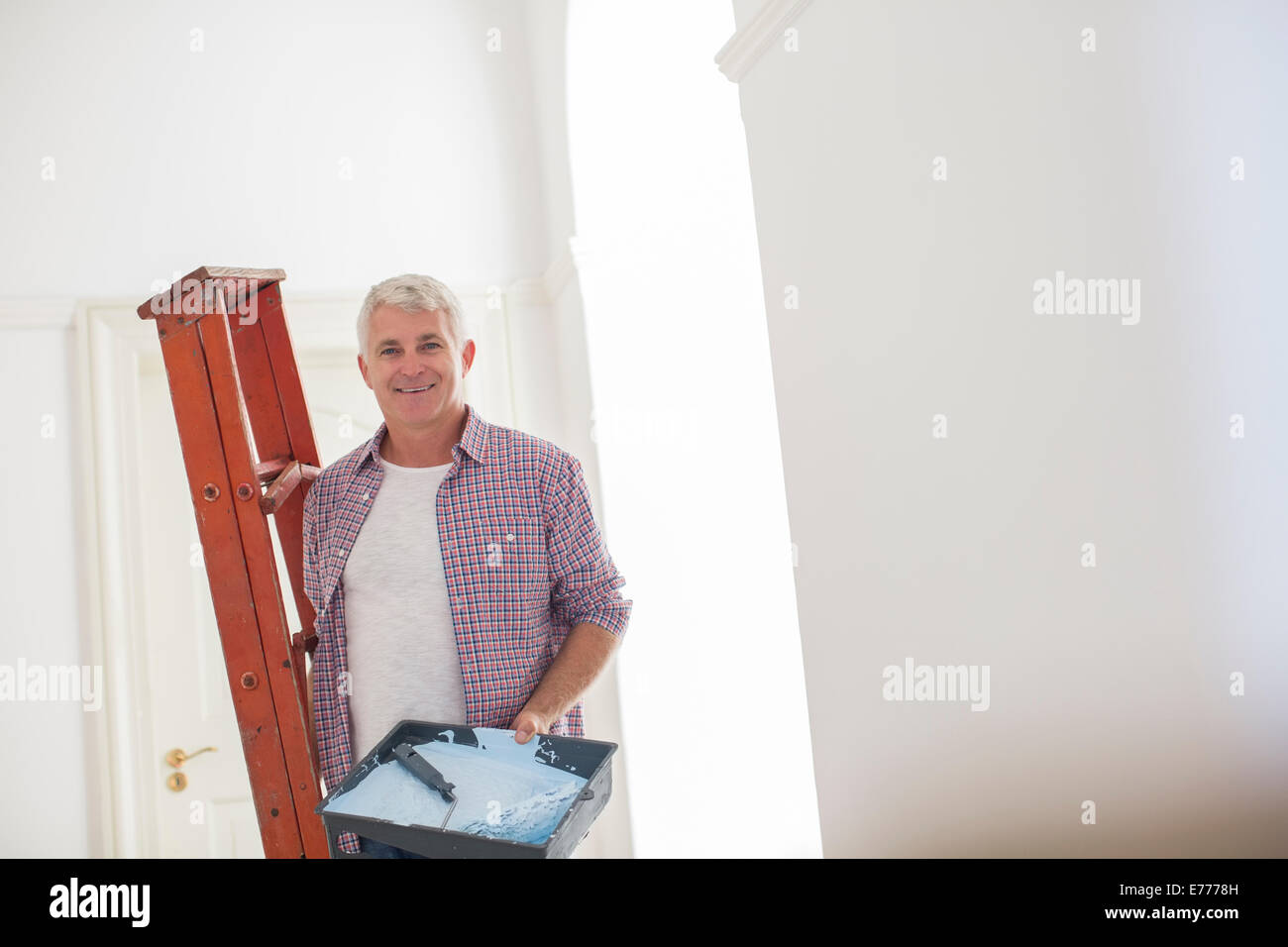 Man up ladder painting hi-res stock photography and images - Alamy