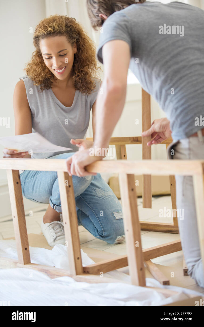 Couple building furniture together Stock Photo - Alamy