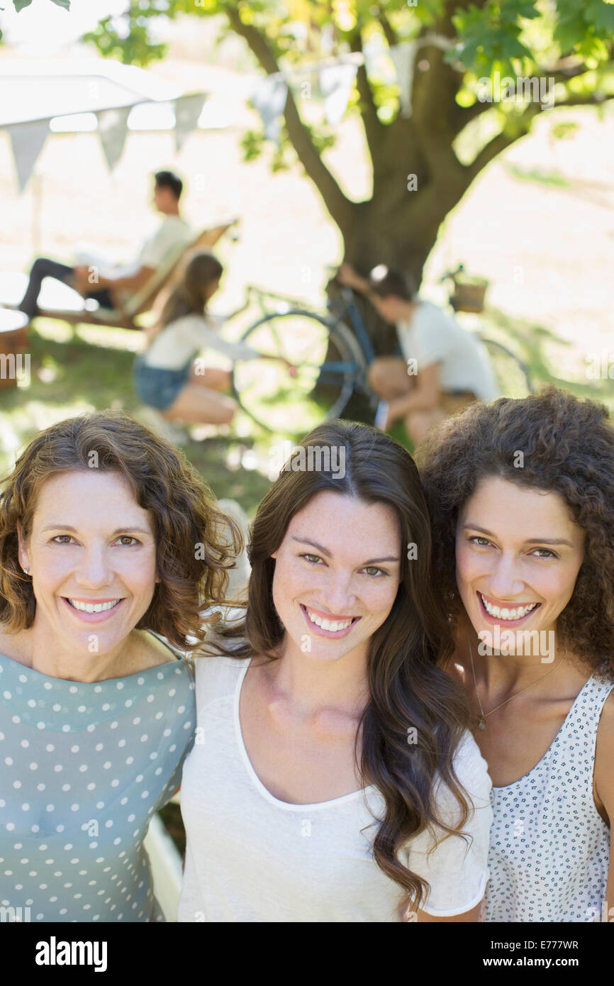 Three women hugging outdoors Stock Photo - Alamy