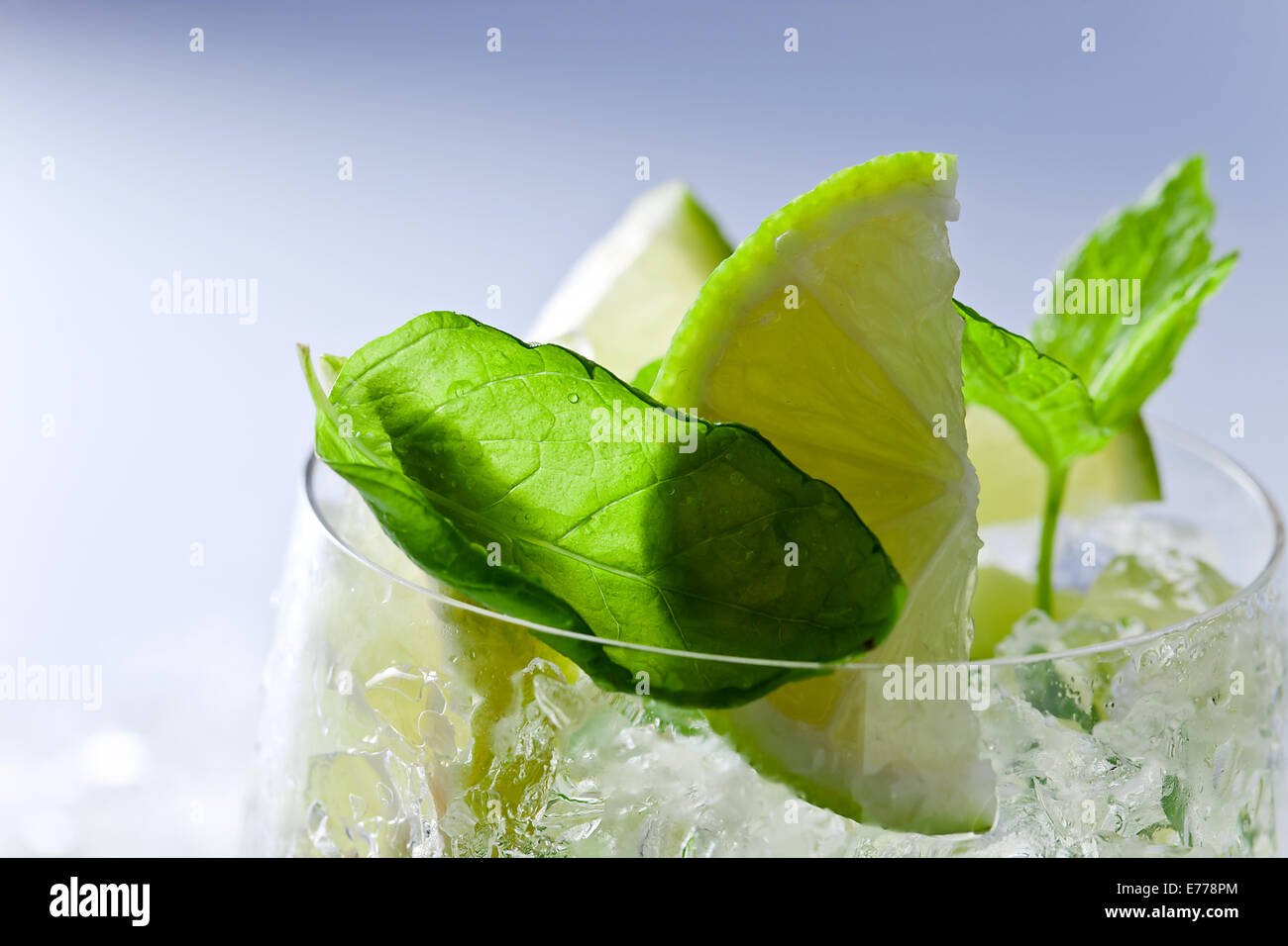 lime pieces and leaves of mint with ice Stock Photo - Alamy