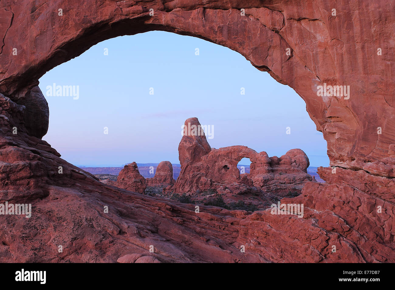 Turret Arch seen through the North Window Arch at sunrise in Arches ...