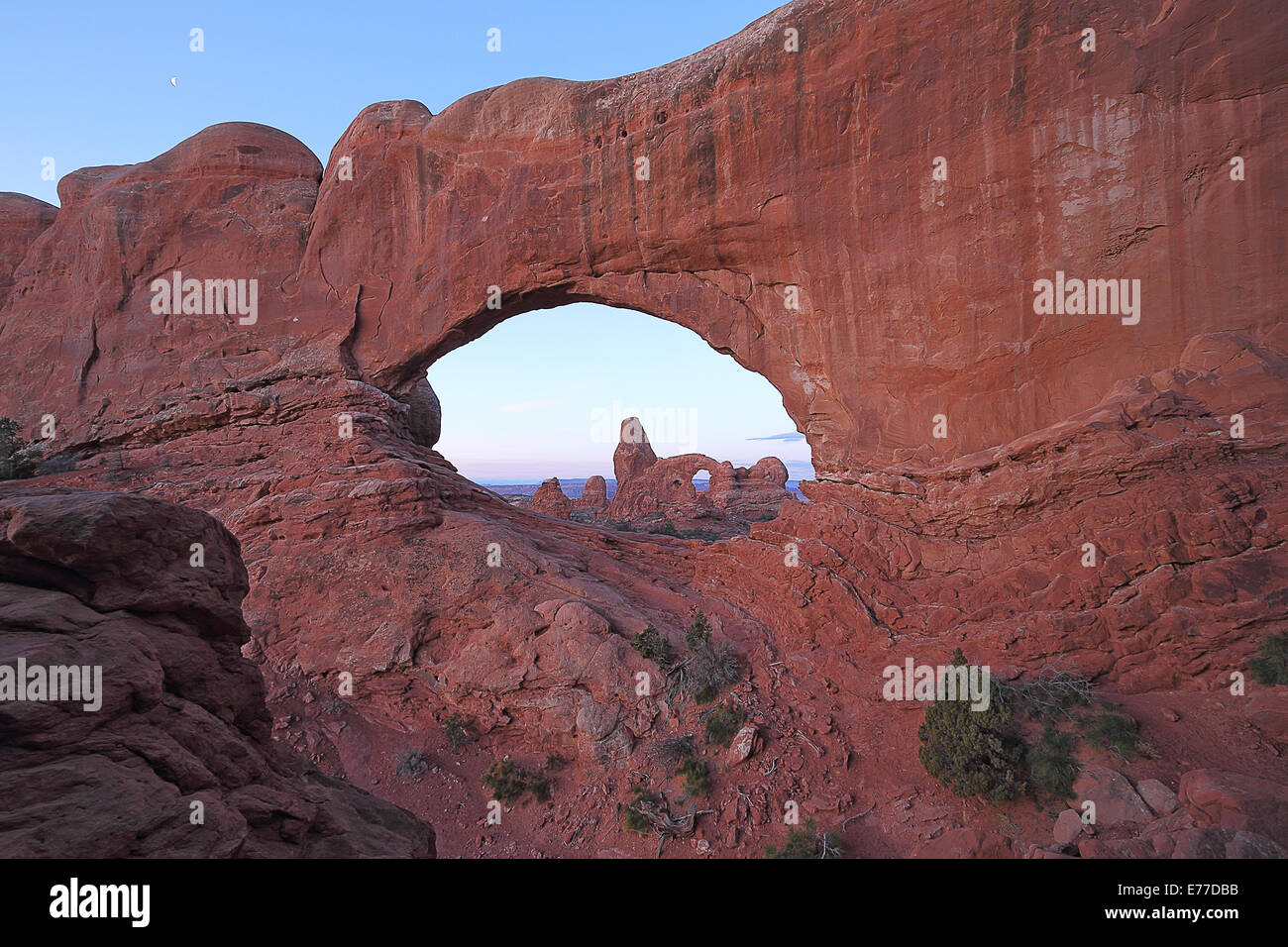 Turret Arch seen through the North Window Arch at sunrise in Arches ...