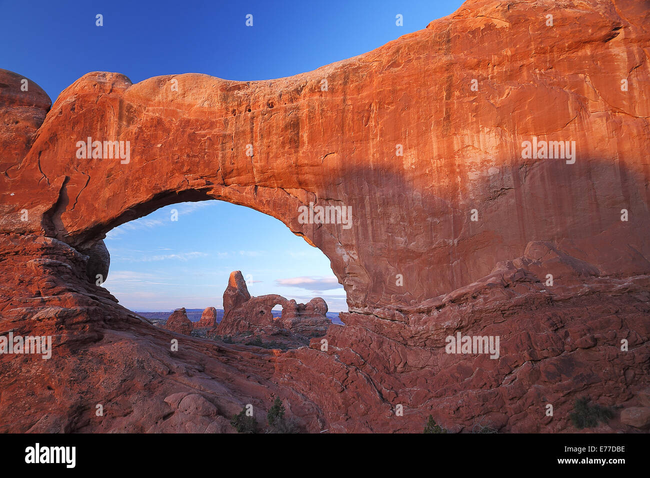 Turret Arch seen through the North Window Arch at sunrise in Arches ...