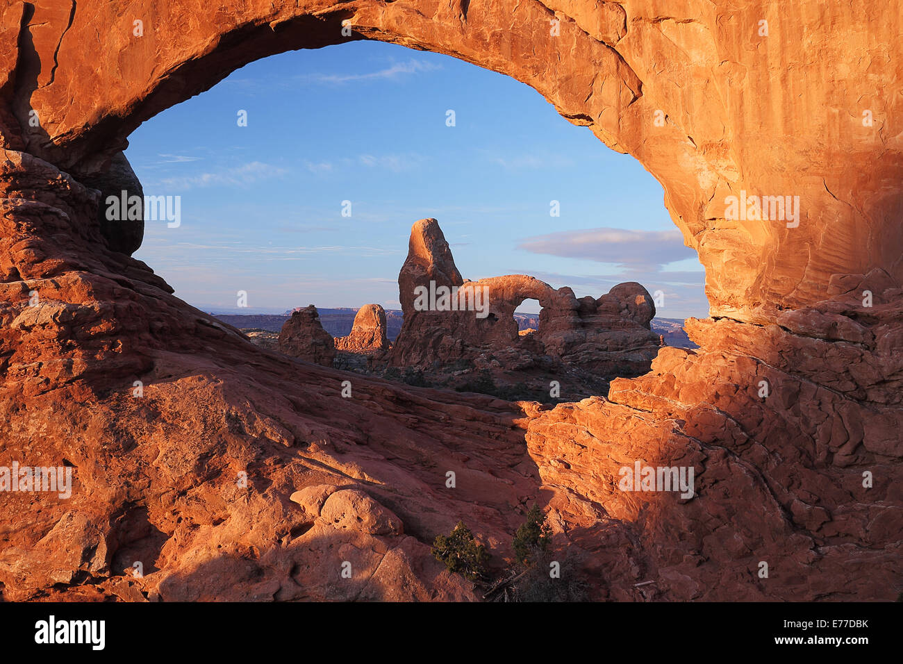Turret Arch seen through the North Window Arch at sunrise in Arches ...