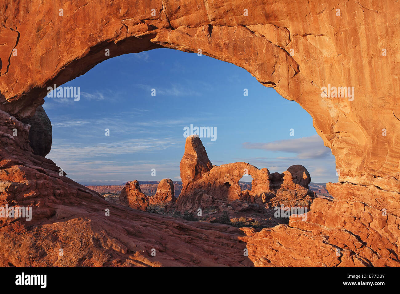 Turret Arch seen through the North Window Arch at sunrise in Arches ...