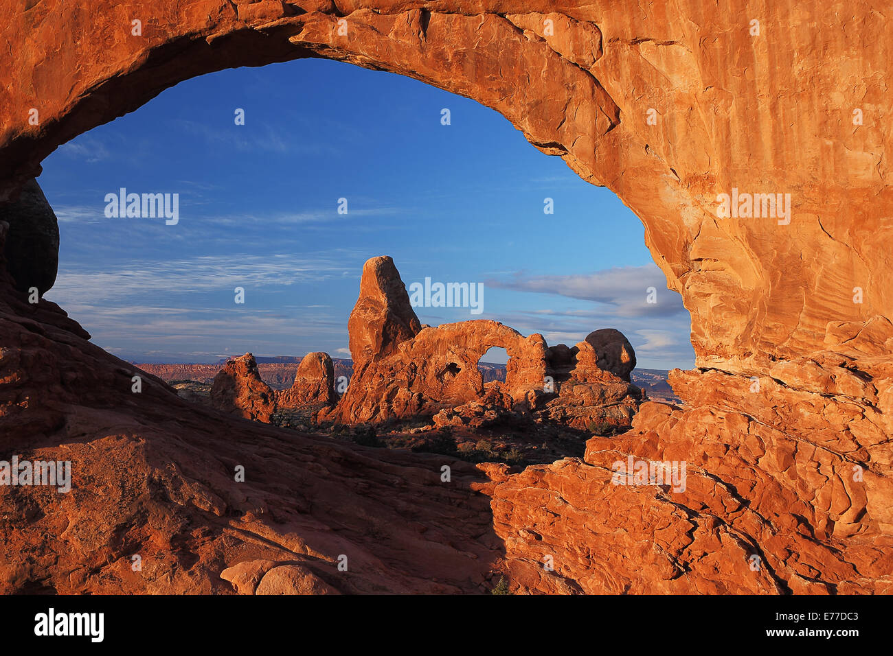 Turret Arch seen through the North Window Arch at sunrise in Arches ...