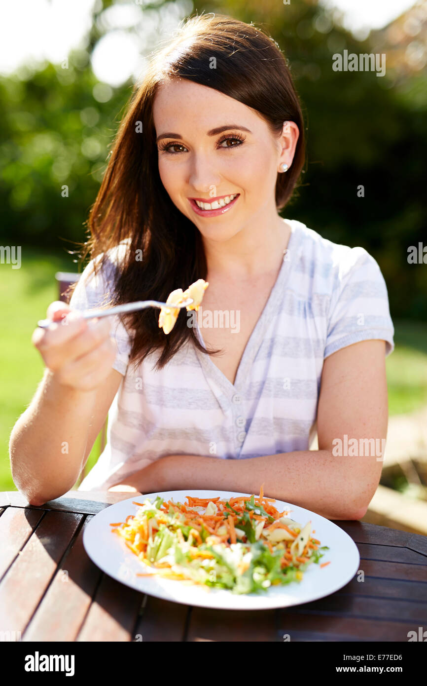 Beautiful girl eating healthy meal outdoors Stock Photo - Alamy