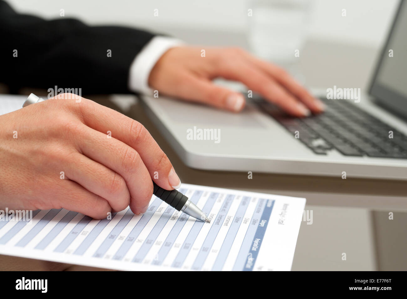 Extreme close up of female business hands working on accounting ...