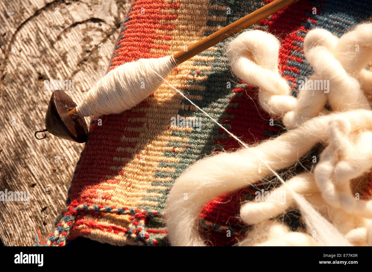 Wool spindle, wool on colored woolen textile Stock Photo - Alamy