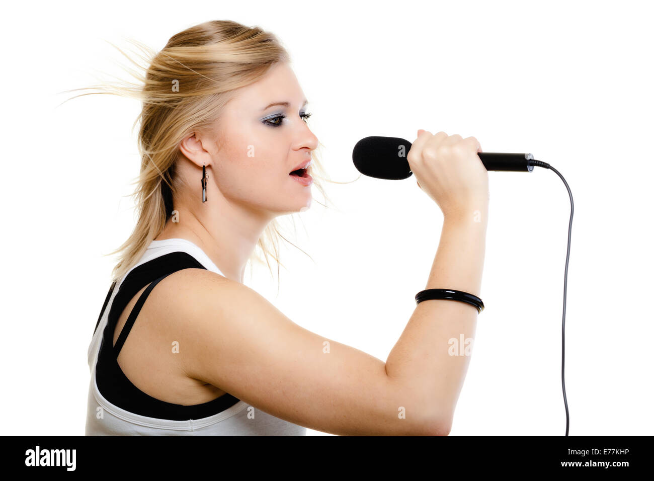 girl singer performer singing to microphone isolated on white. young ...