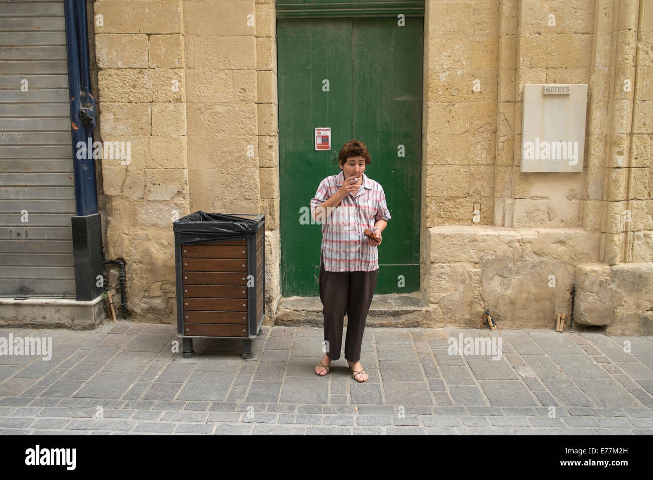 Woman smoking in the street Stock Photo - Alamy