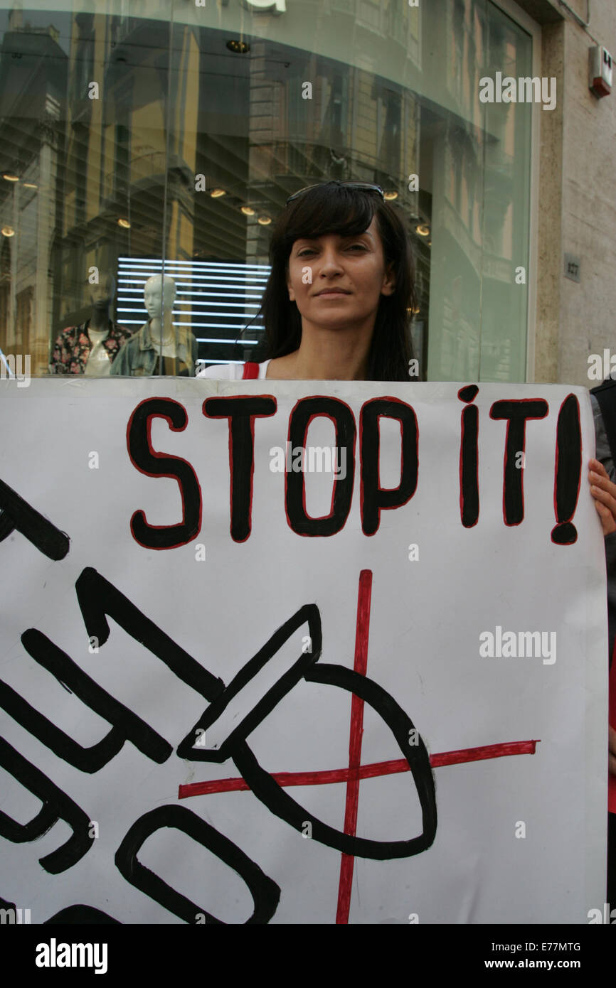 Demonstrators shout slogans and bring placards during a protest ...