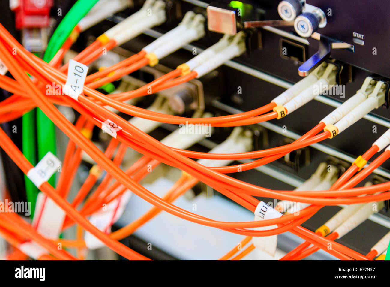 Fiber cables plugged into a high end router machine at a computer data ...