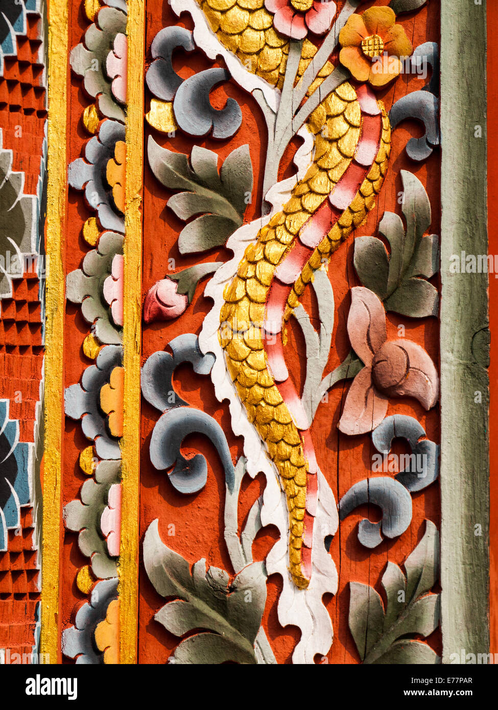 Bhutan traditional carved wooden decoration on red door Stock Photo - Alamy