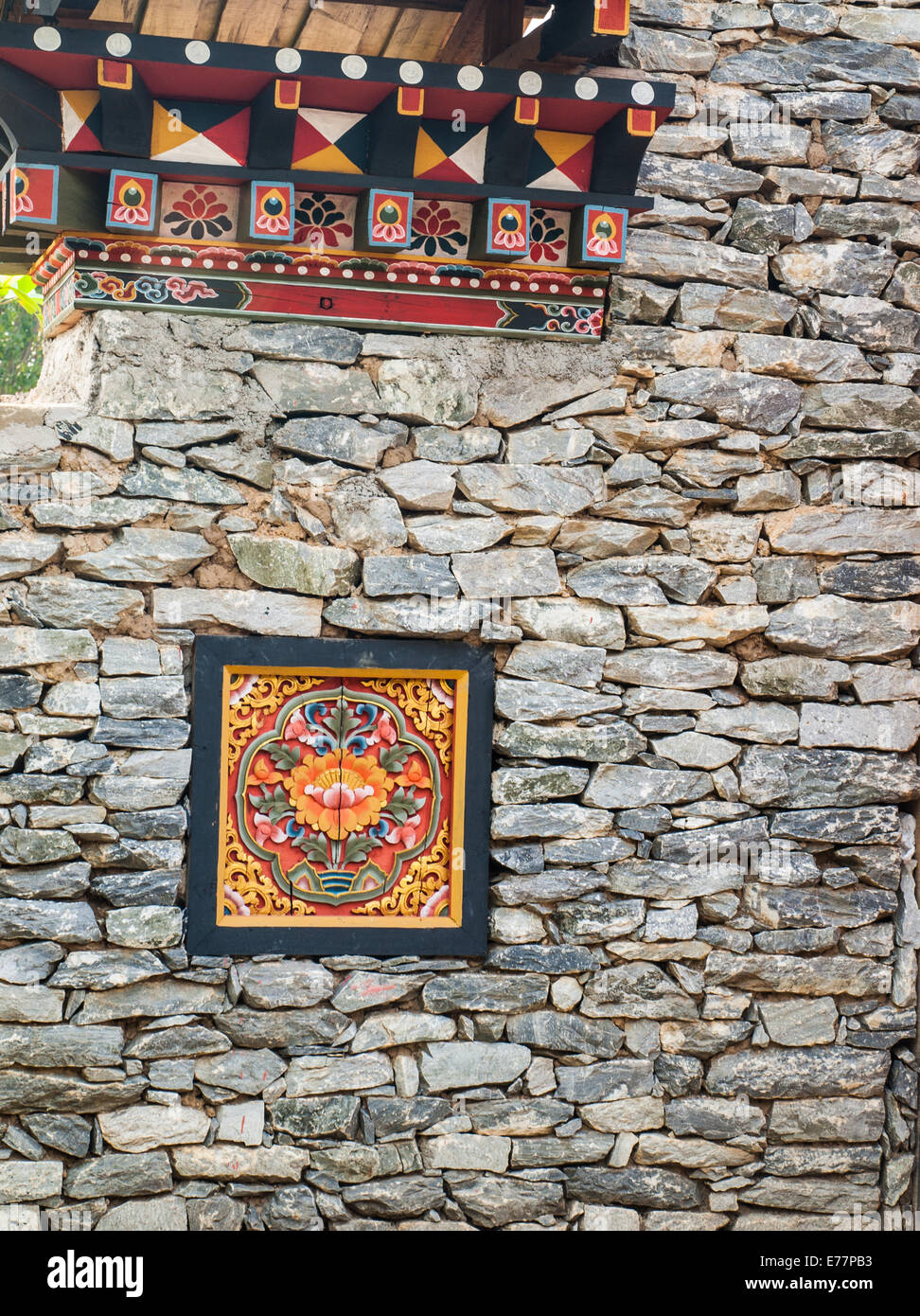 Bhutan traditional wooden decoration in rock wall Stock Photo - Alamy