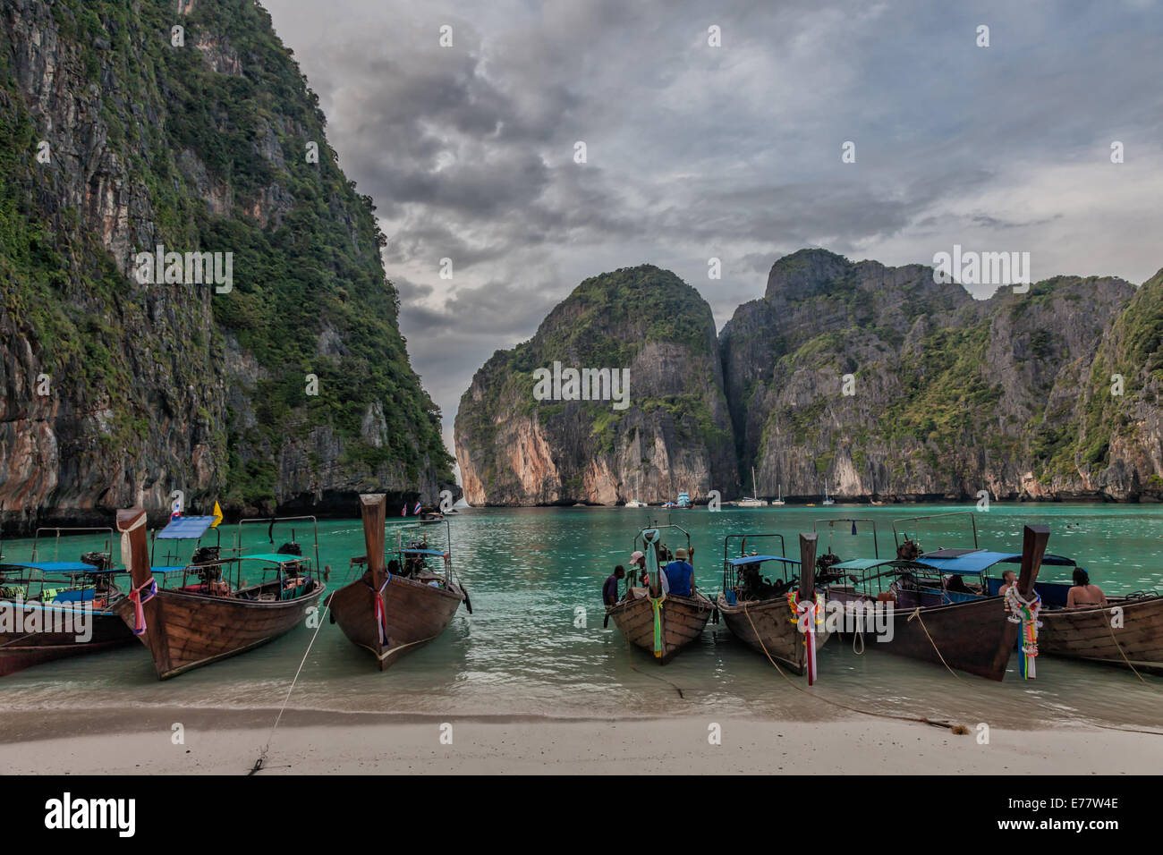 Longboats in a row on May a Beach Thailand Stock Photo - Alamy