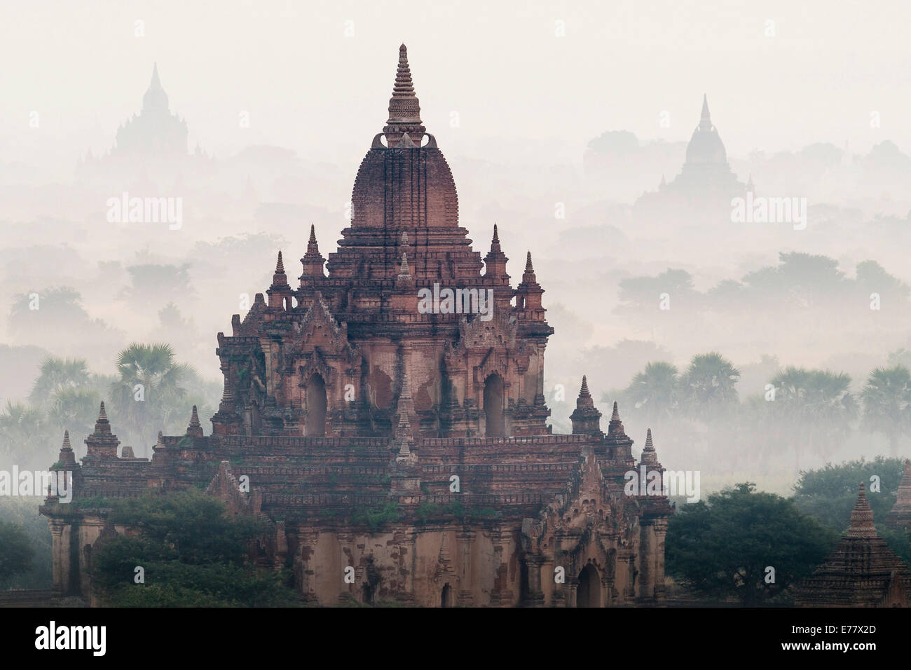 Sunrise, temples in the morning mist, stupas and pagodas in the temple ...