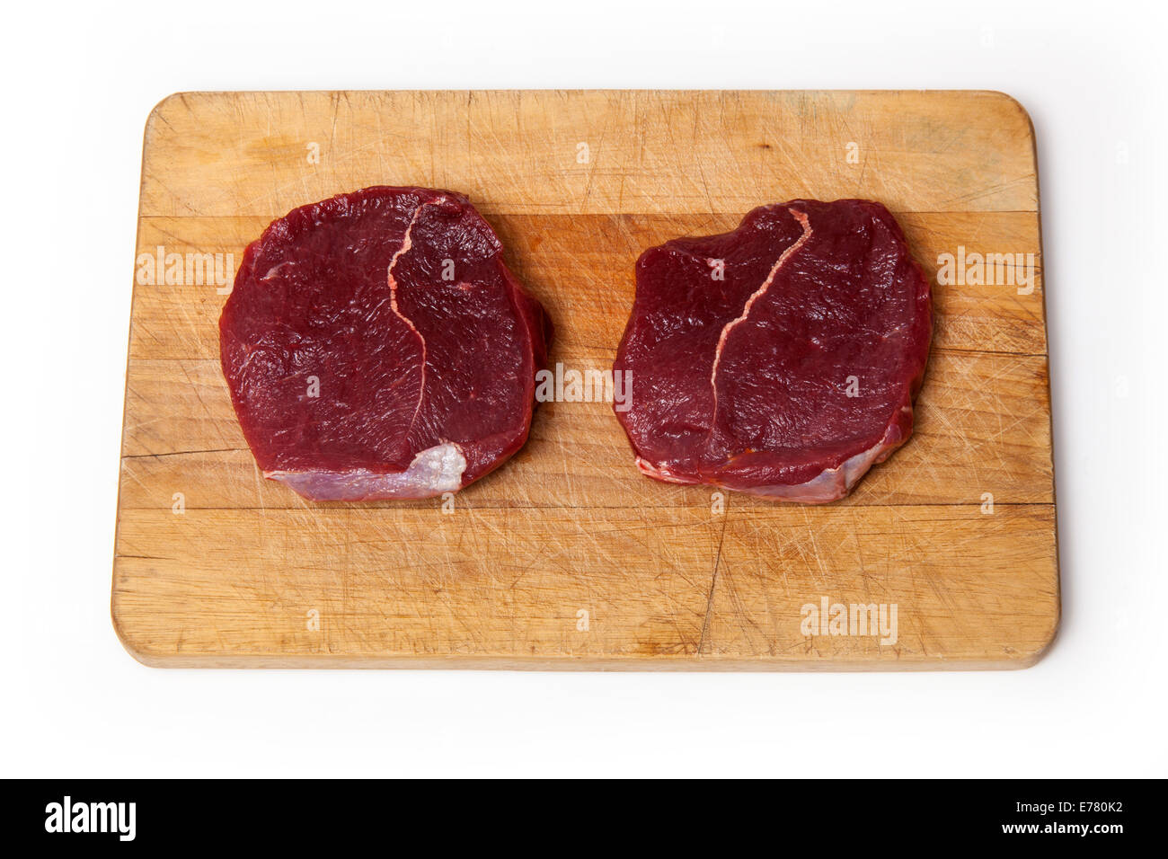 Raw Zebra steaks on a wooden board . Isolated on a white studio ...