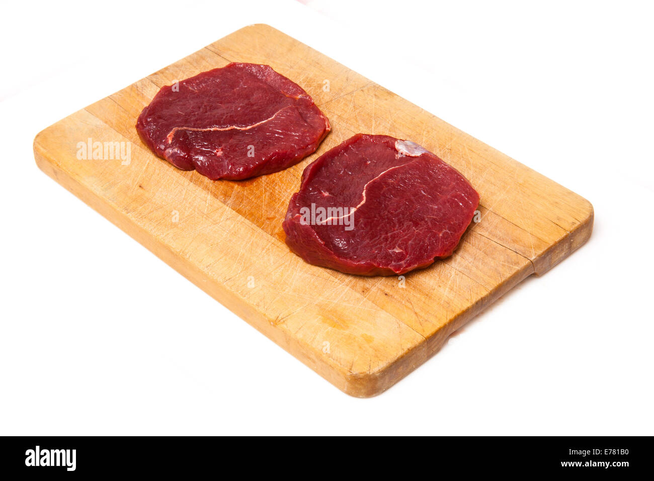 Raw Zebra steaks on a wooden board . Isolated on a white studio ...