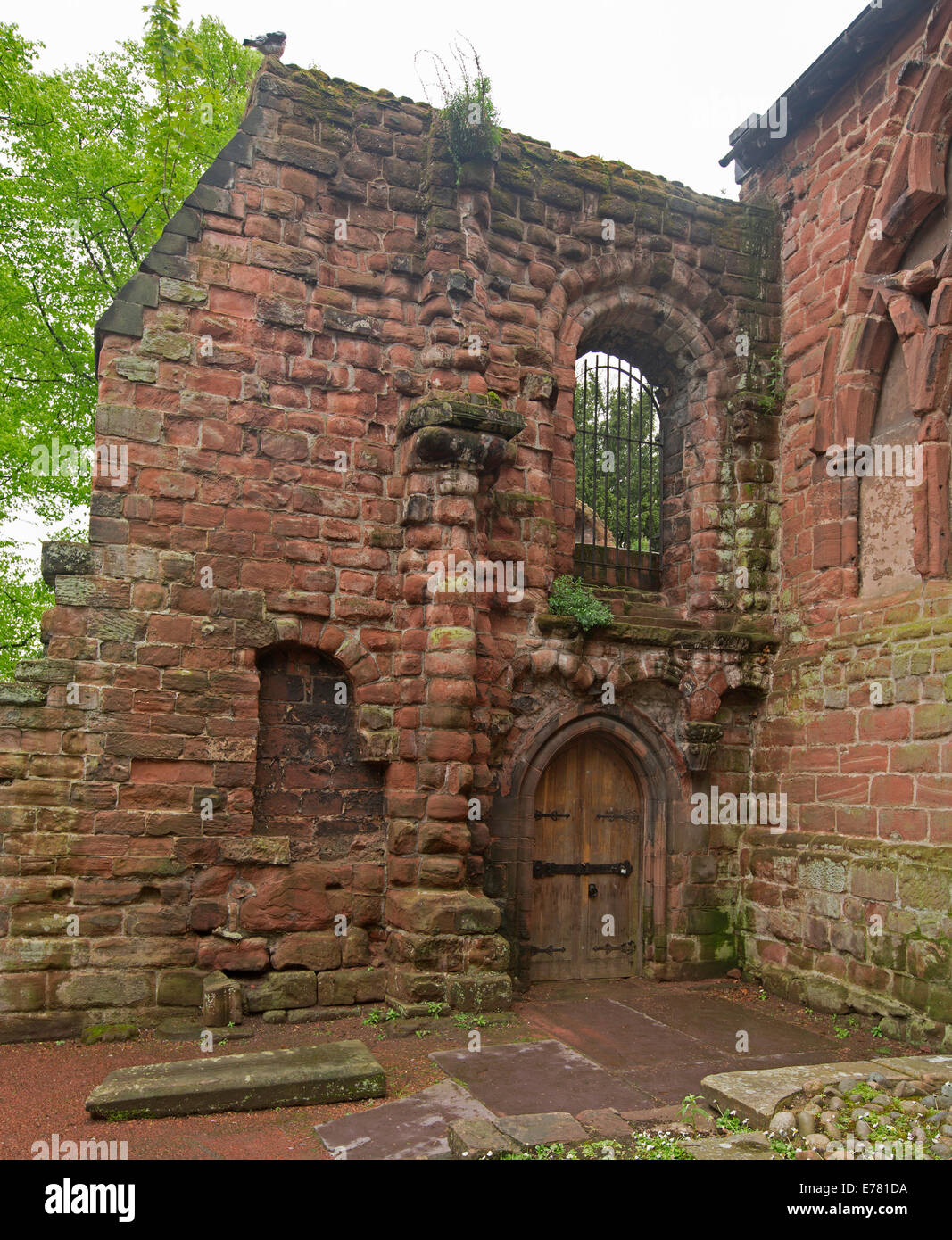 Ruins of St. John's church, with archways and walls of red brick coated ...