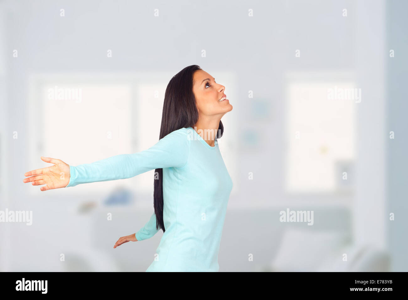 Happy Woman with Arms Wide Open in her house Stock Photo - Alamy
