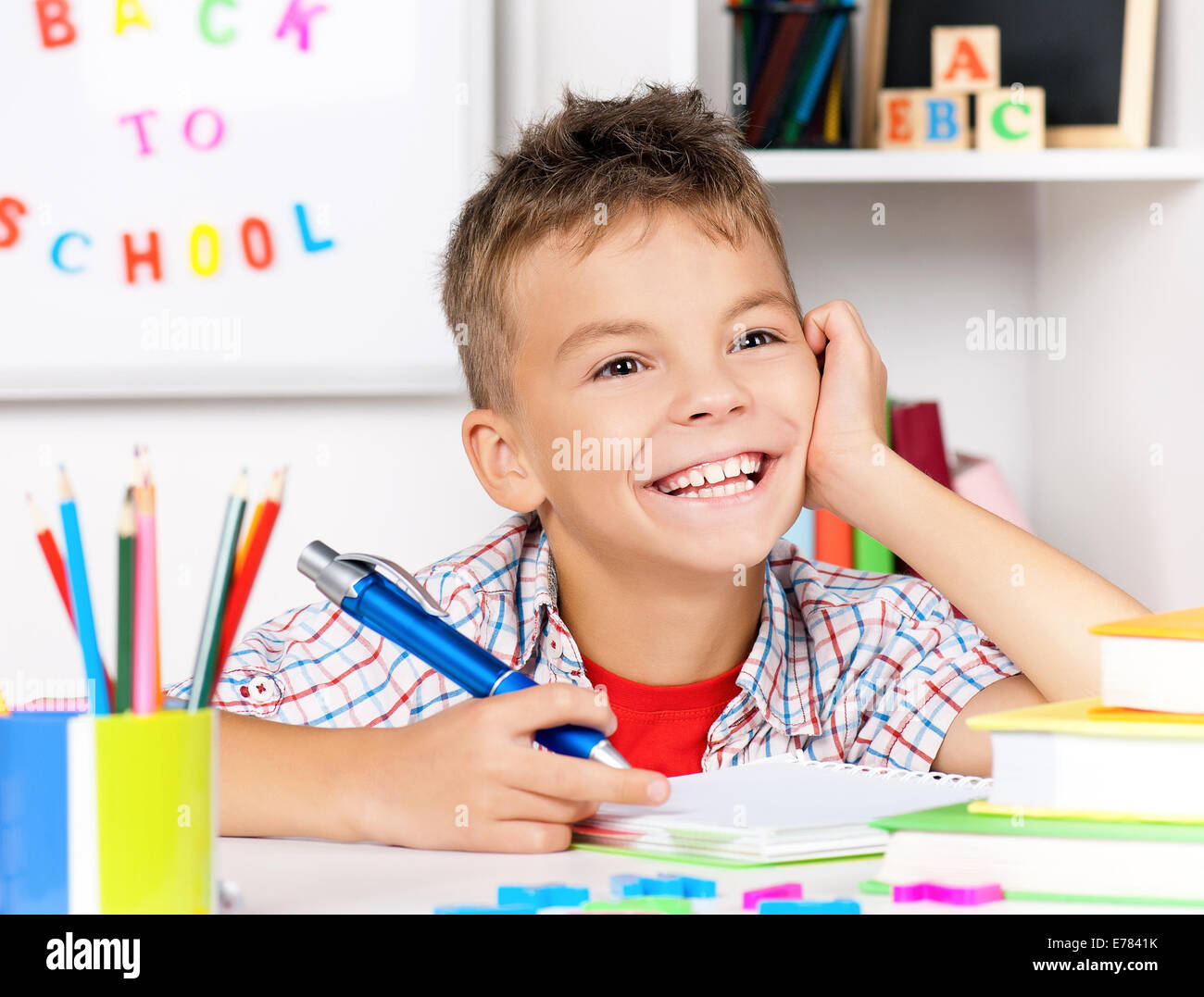 Desk boy homework smiling hi-res stock photography and images - Alamy