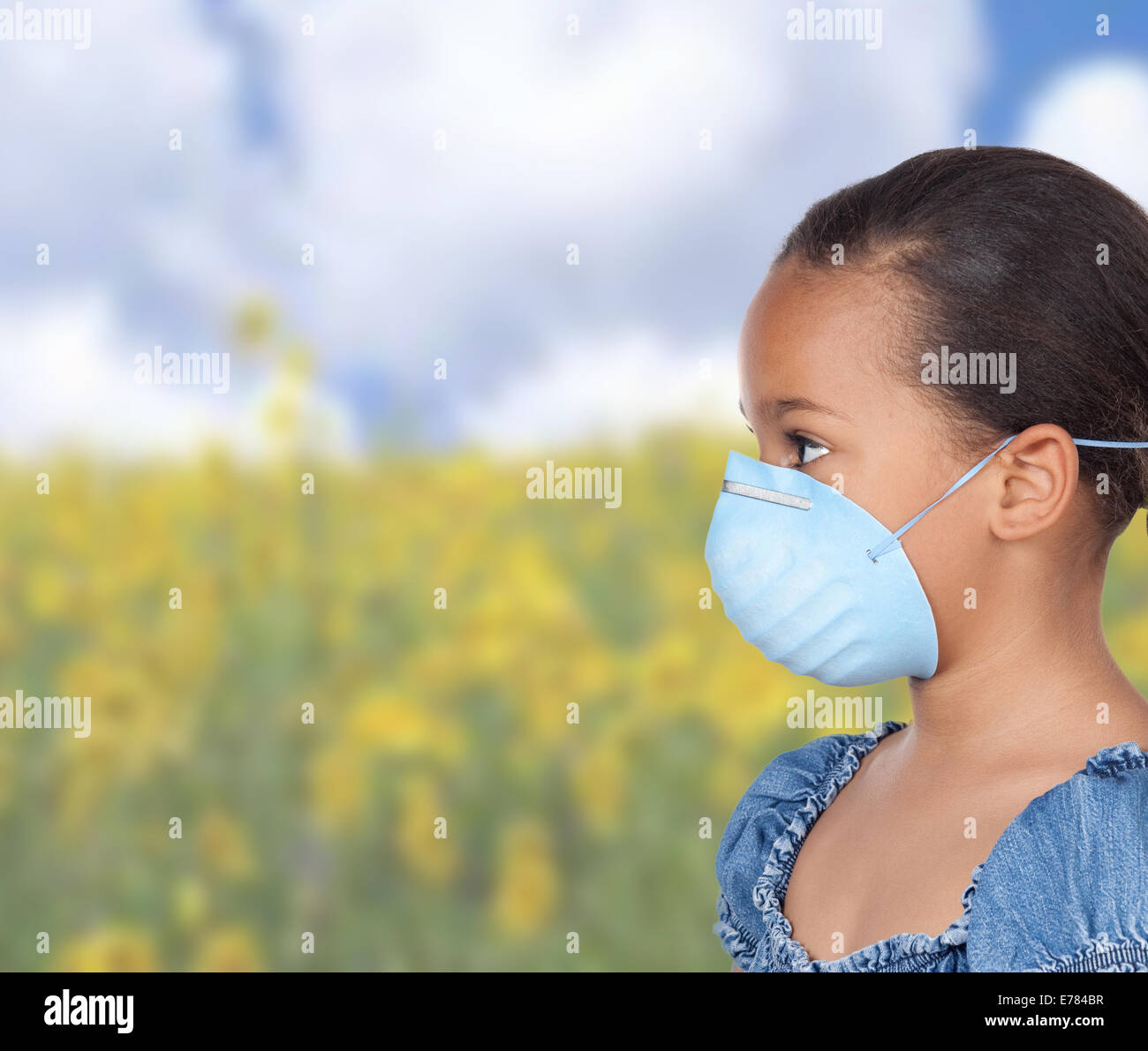 Allergic latin girl with a blue mask in a field with many flowers Stock ...
