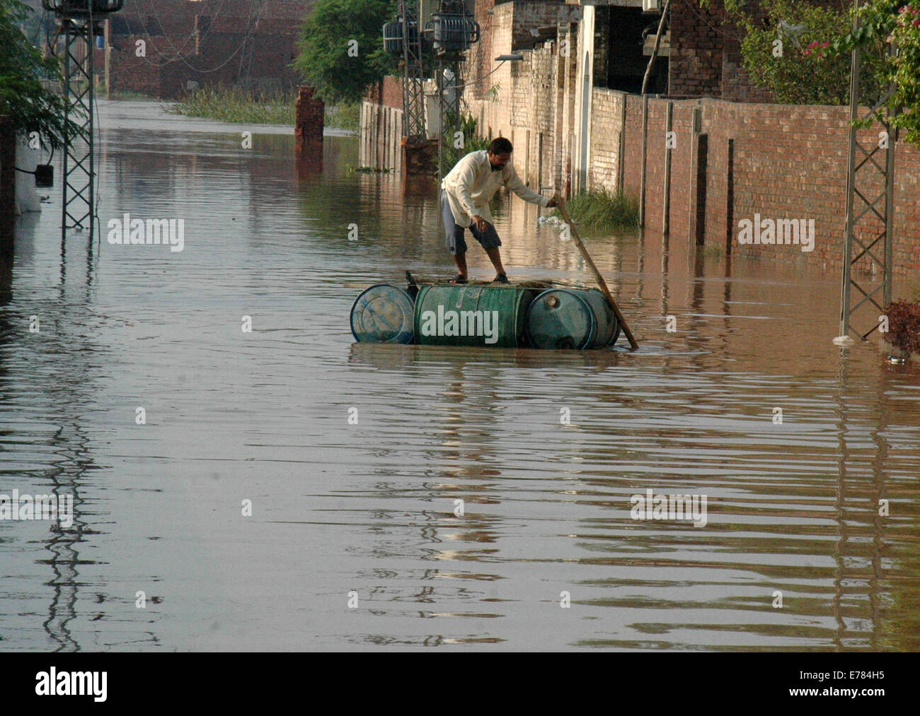 Lahore. 9th Sep, 2014. A man wades through flood water from an flood ...