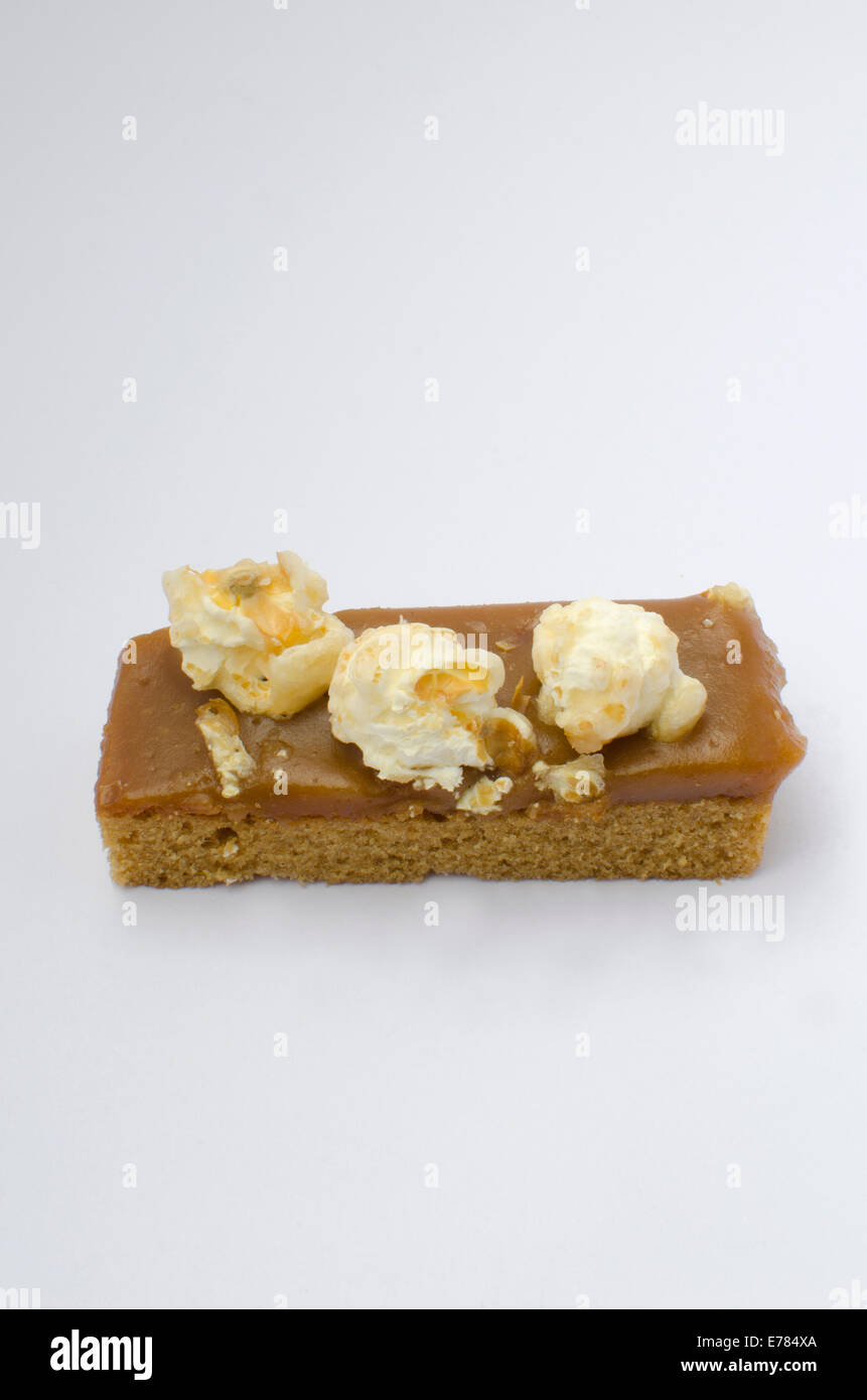 Sticky toffee popcorn cake slice on white background Stock Photo - Alamy