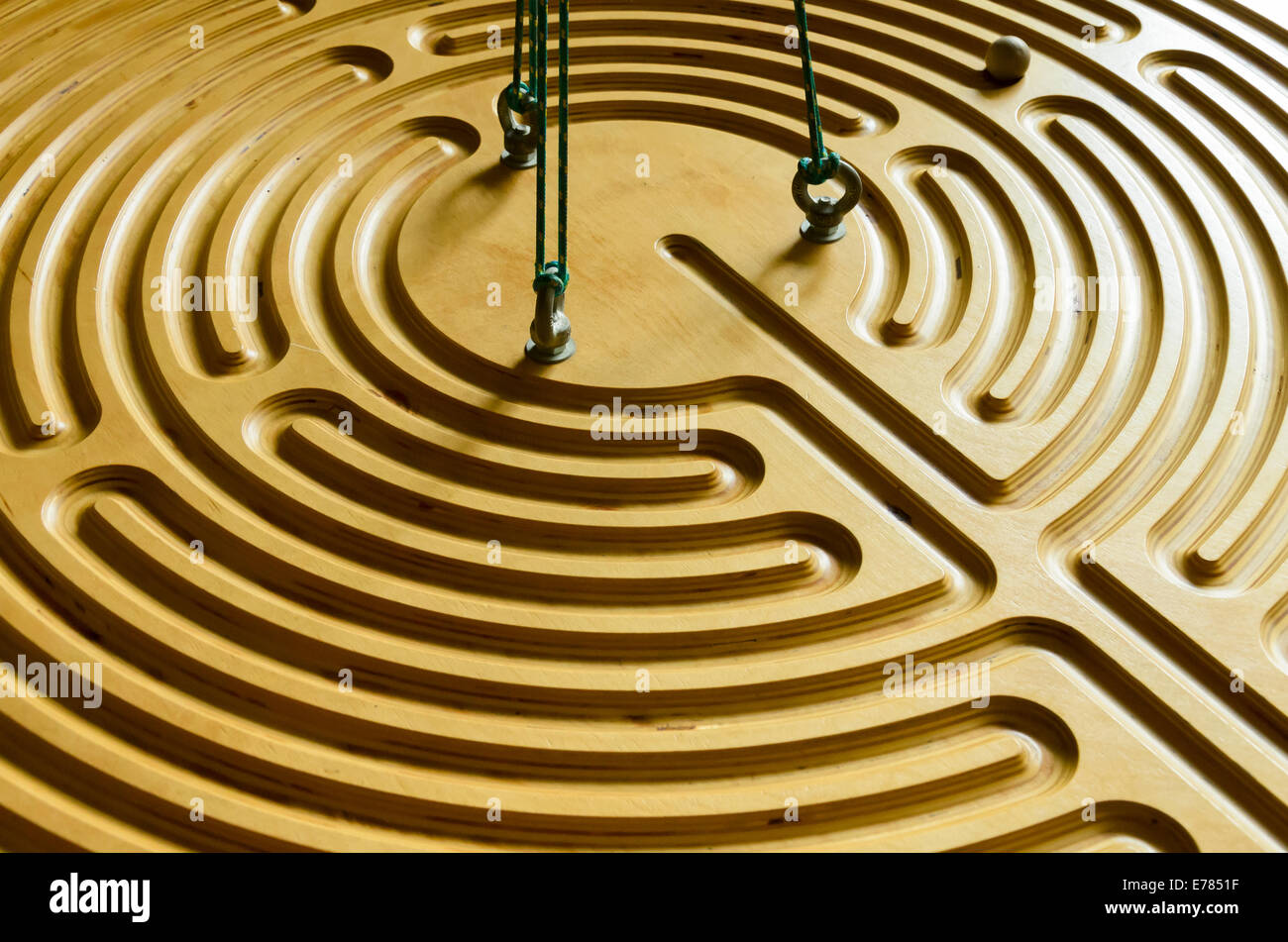 Wooden puzzle on cables Stock Photo - Alamy